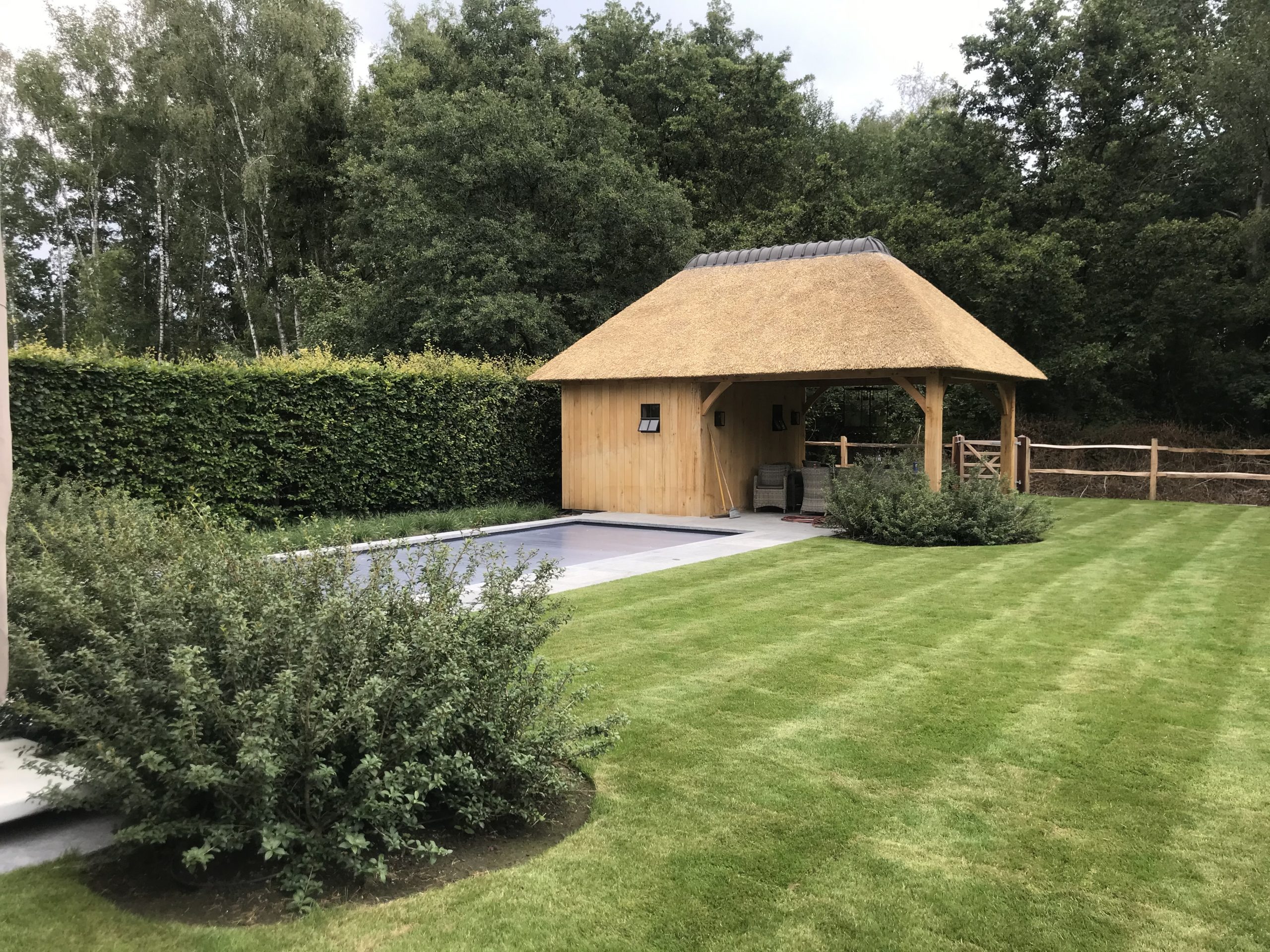 Oak pool house with thatched roof