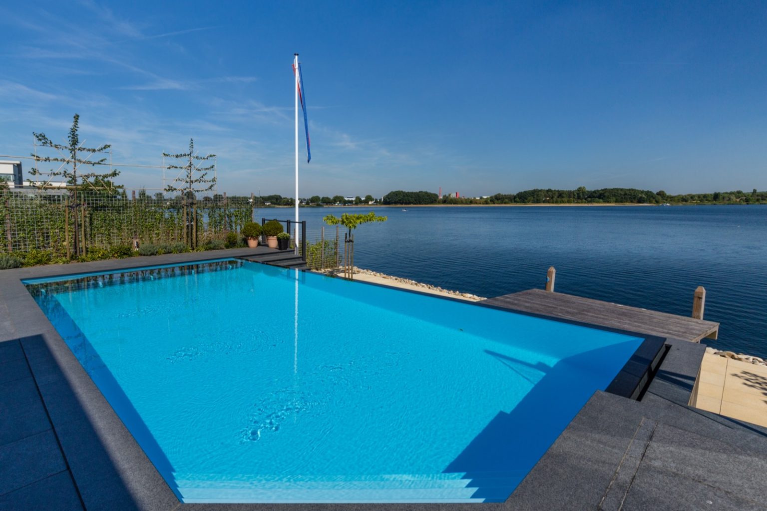 Infinity pool with overflow channel and natural stone bench seating