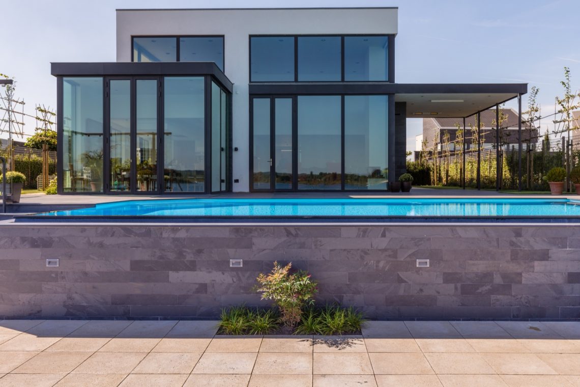 Infinity pool with overflow channel and natural stone bench seating
