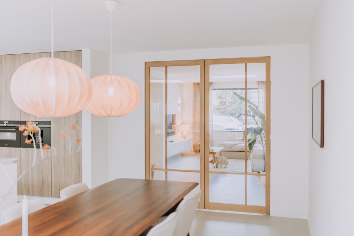 Oak pivot doors in combination with cast floor in Hellendoorn