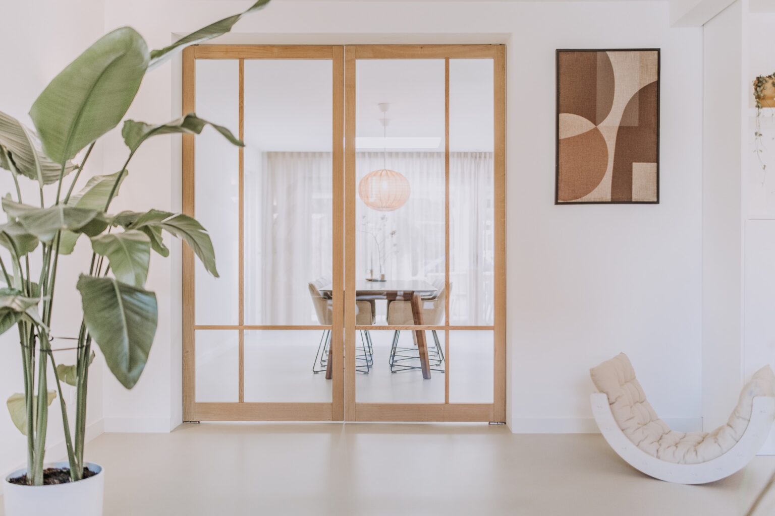 Oak pivot doors in combination with cast floor in Hellendoorn