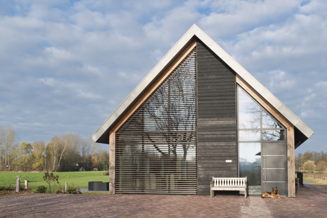 Barn house fitted with slatted western red cedar blinds