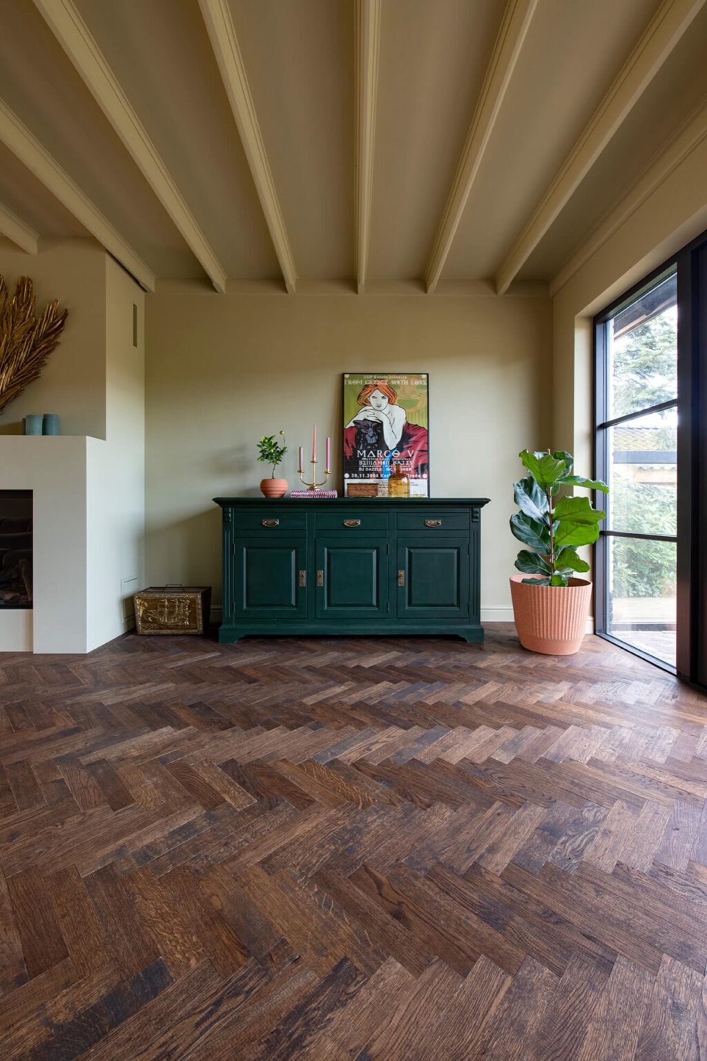 Dark herringbone floor with black kitchen with marble countertops